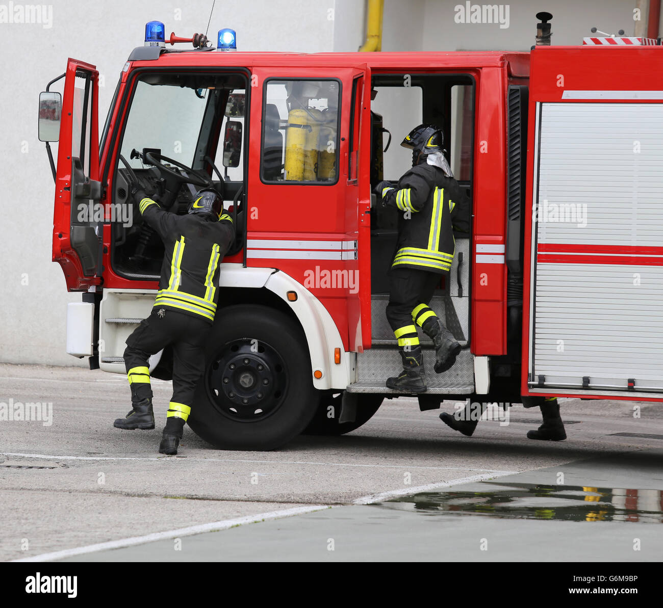 fire engine carrying firefighters and equipment for fighting fire Stock ...