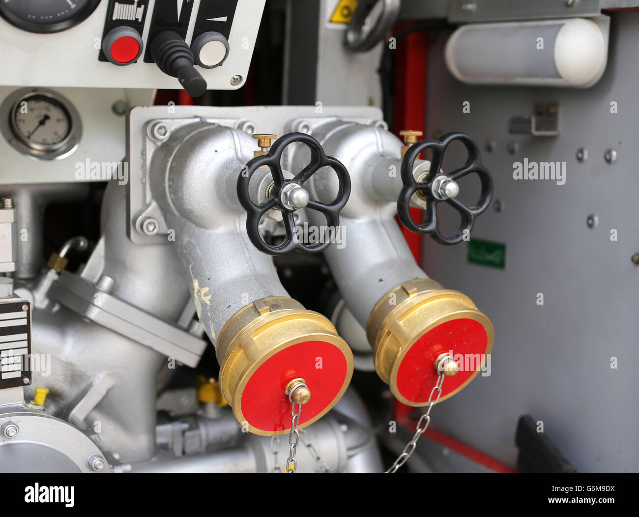 large fire control equipment with taps and hoses of firefighters in ...