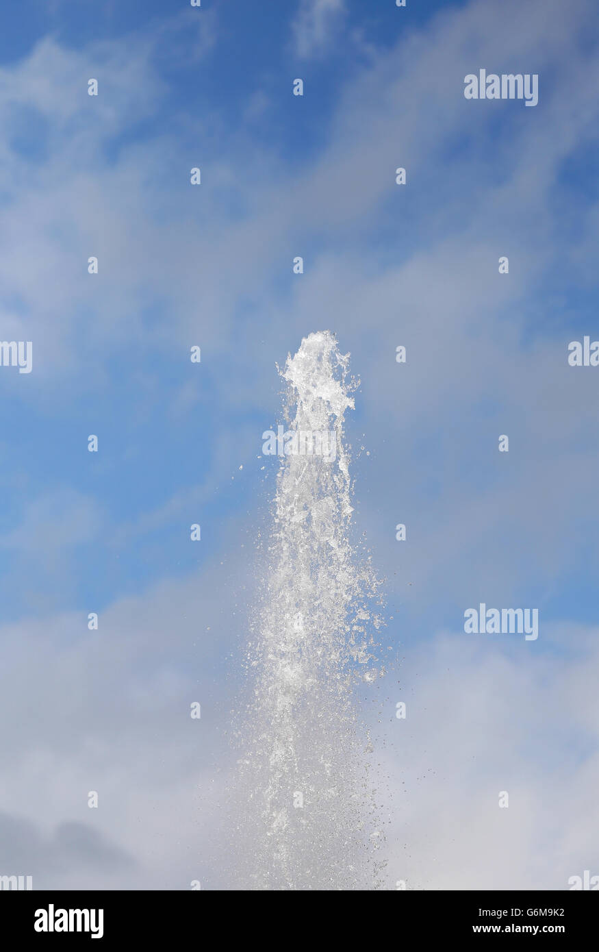 high water jet in the background of the blue sky with white clouds ...
