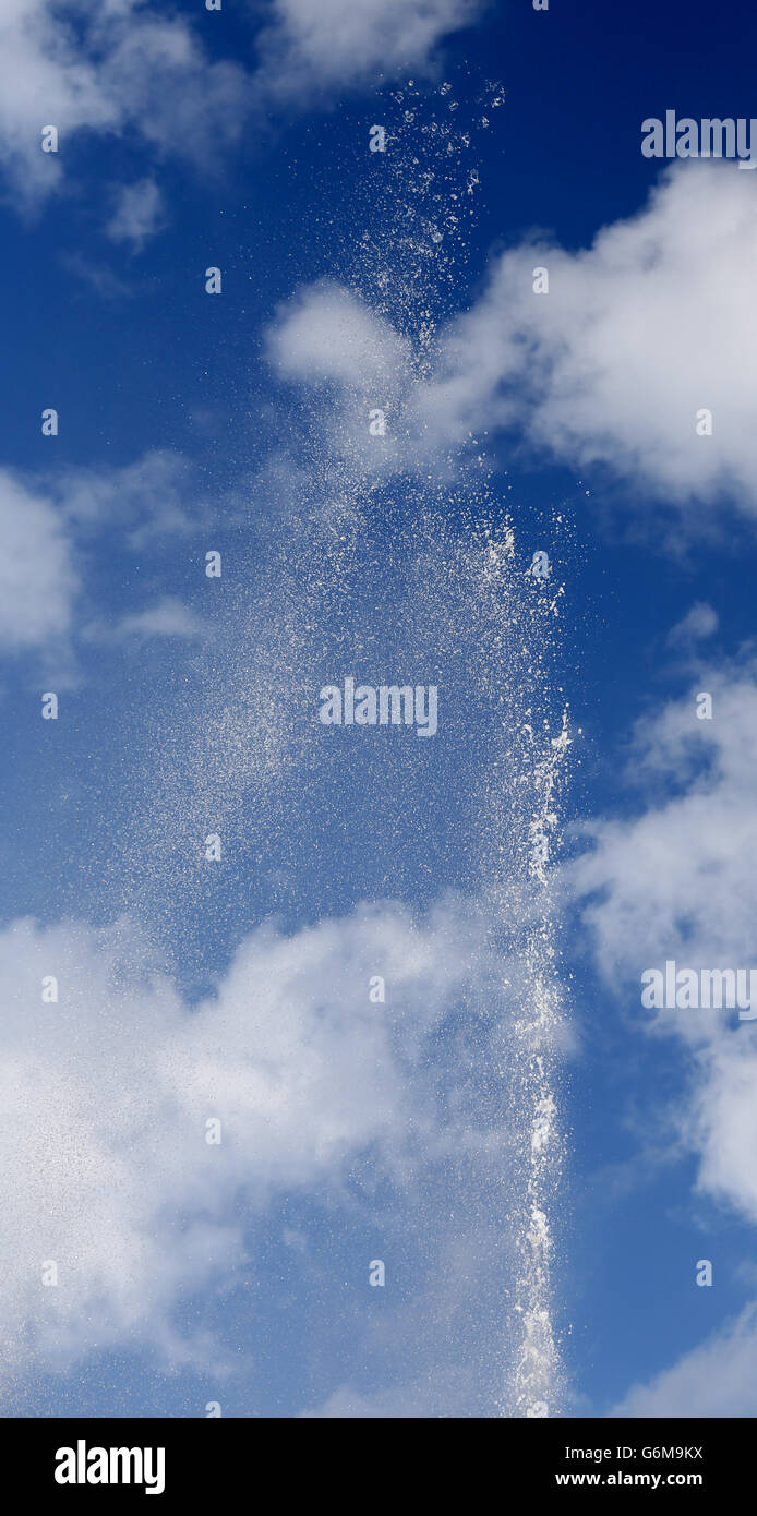high water jet and the background of the blue sky with white clouds ...