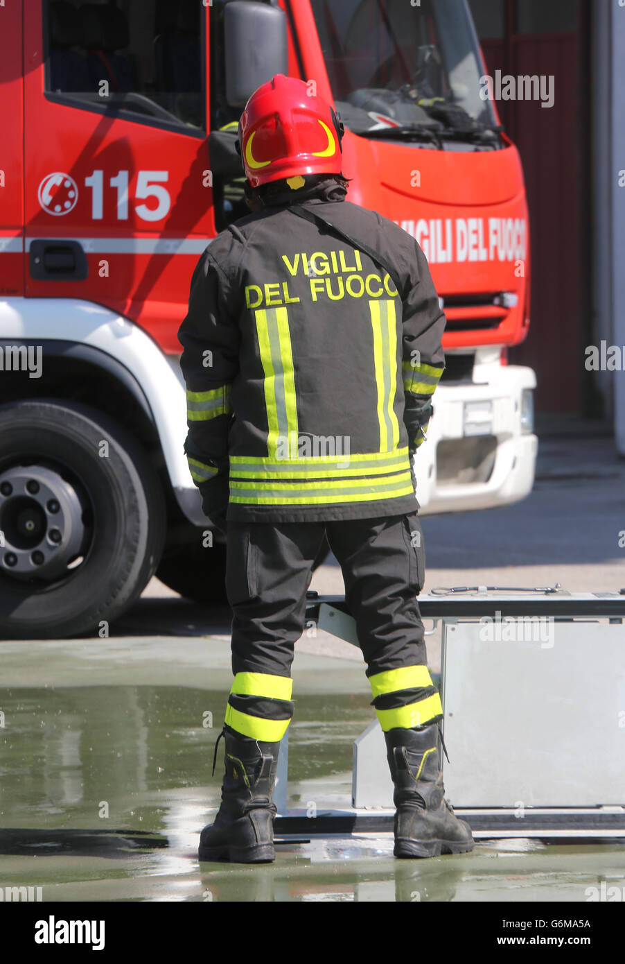 isolated Italian fireman with protective uniform and red helmet on his ...