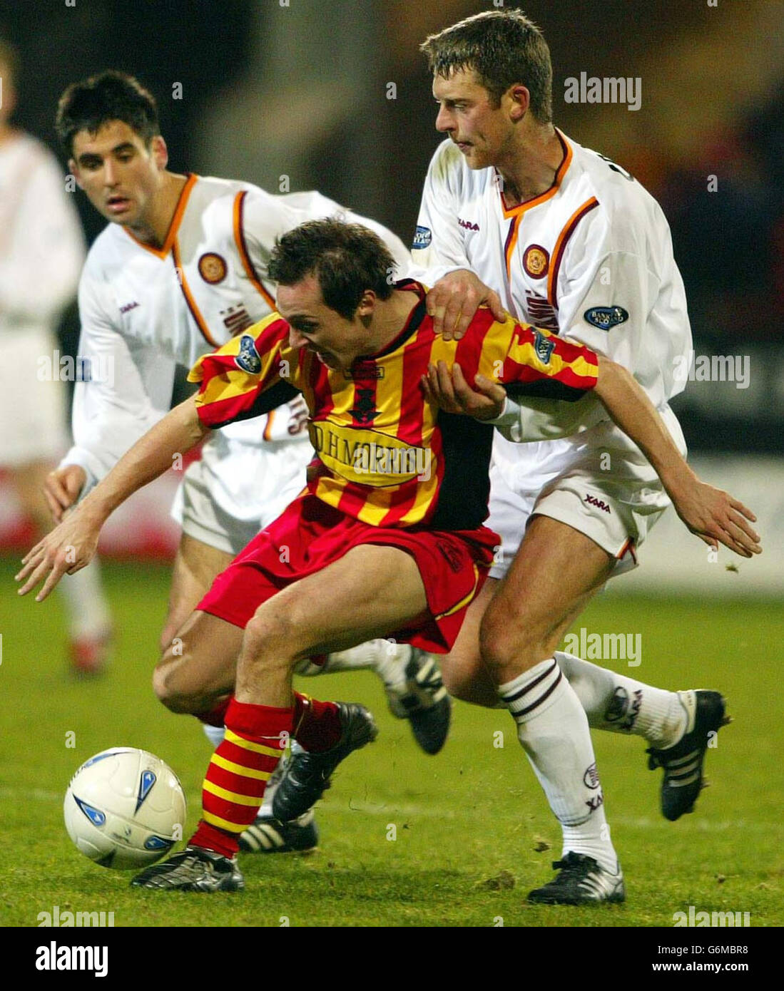 Jamie Mitchell of Partick Thistle with Motherwell's Stephen Craigan ...