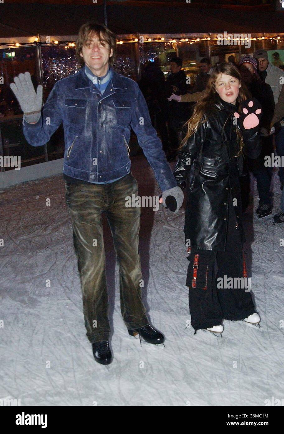 TV presenter Jonathan Ross with his daughter, skating on the ice rink ...