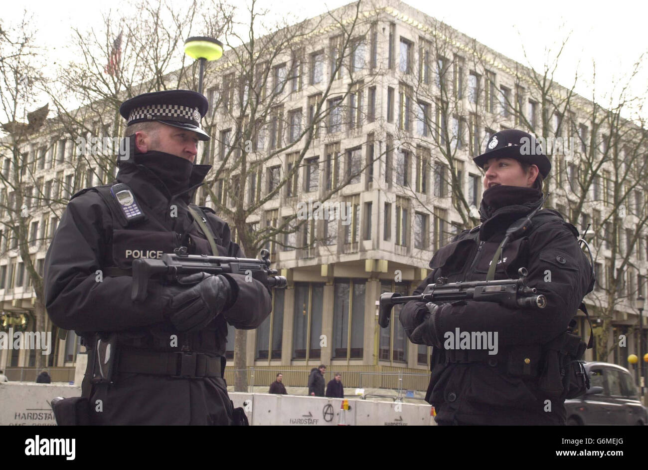 Two armed police officers stand guard outside the American Embassy in ...