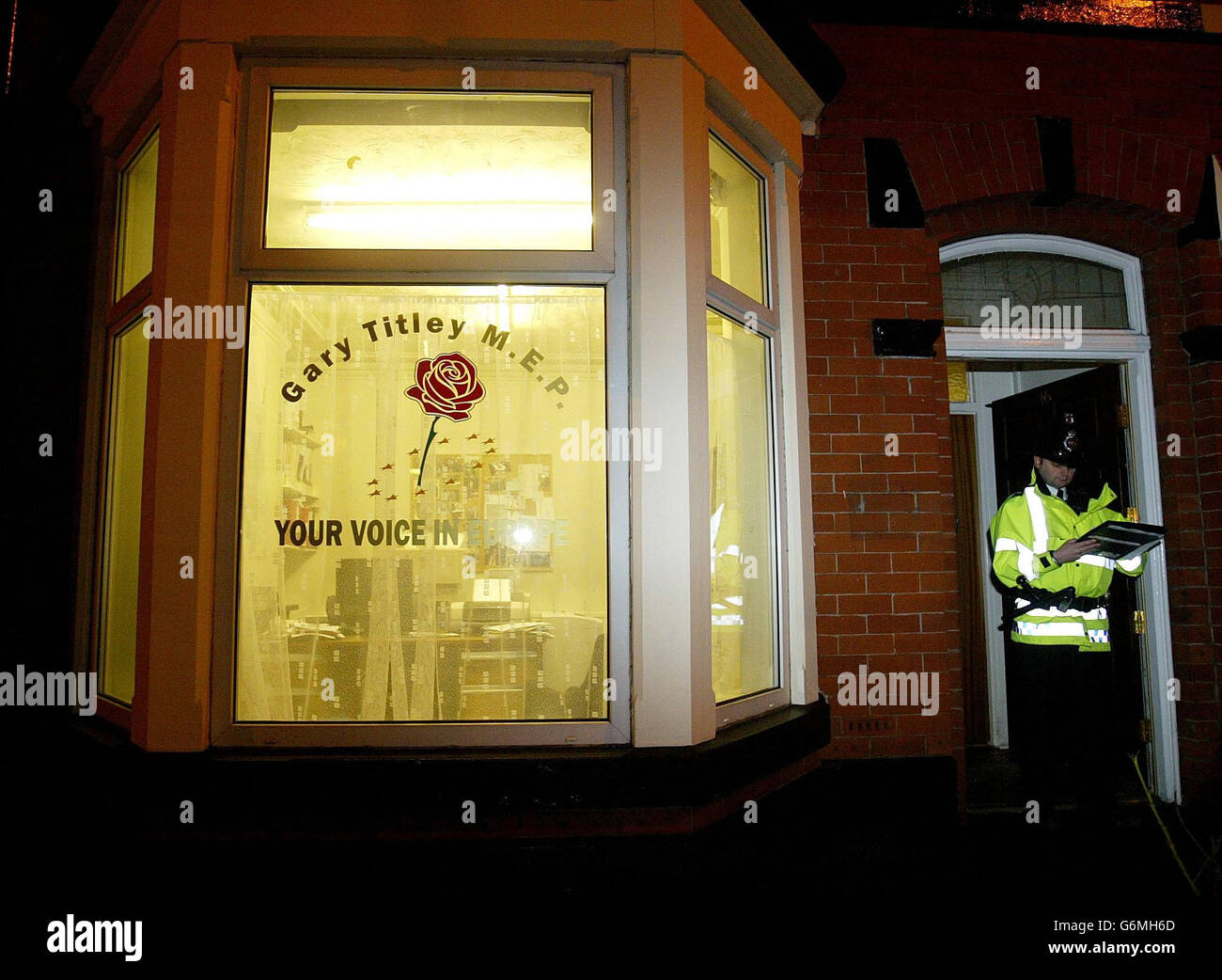 A Policeman stands guard at the doorway of British MEP, Gary Titley ...