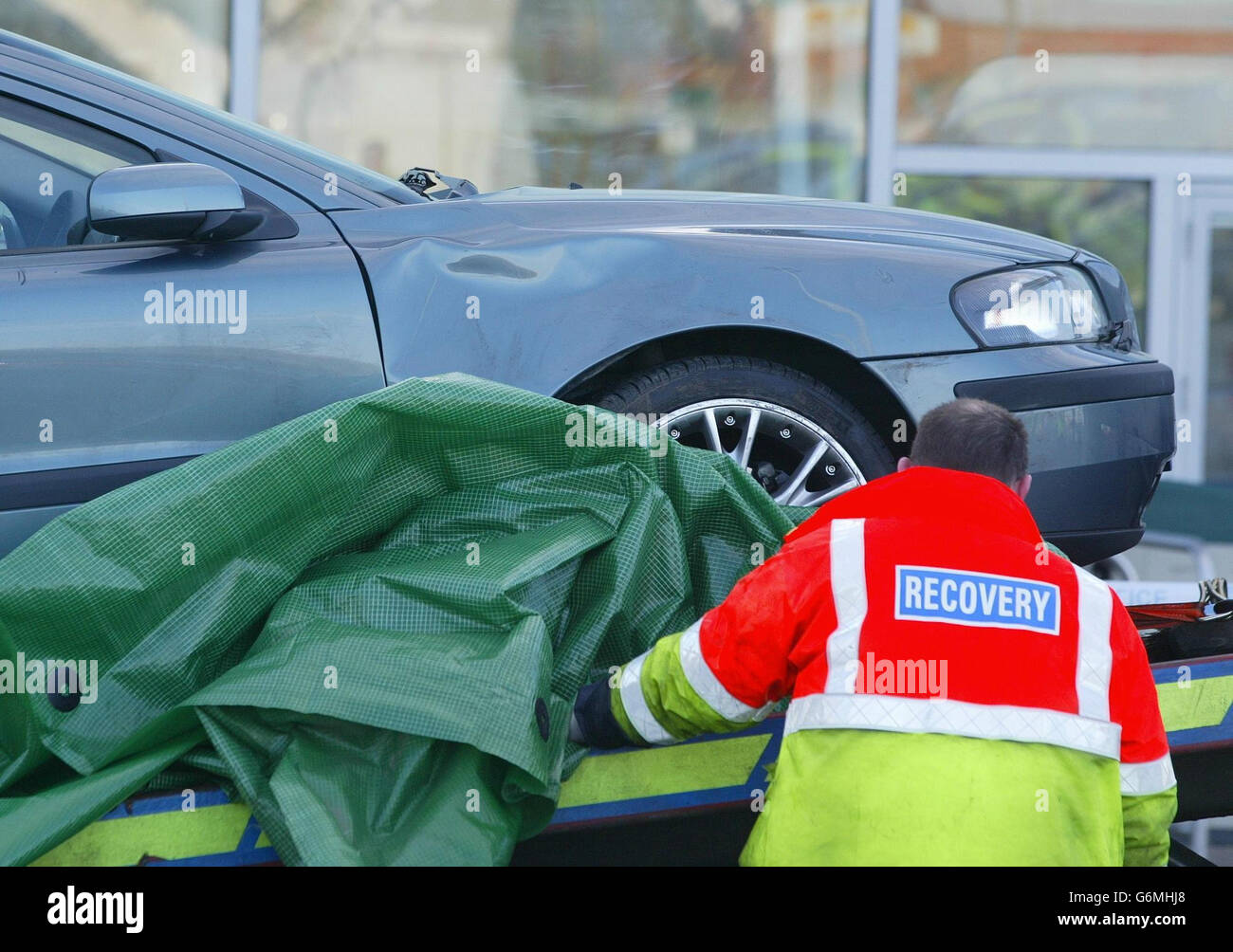 Recovery workers load the Volvo car involved in this morning's incident ...