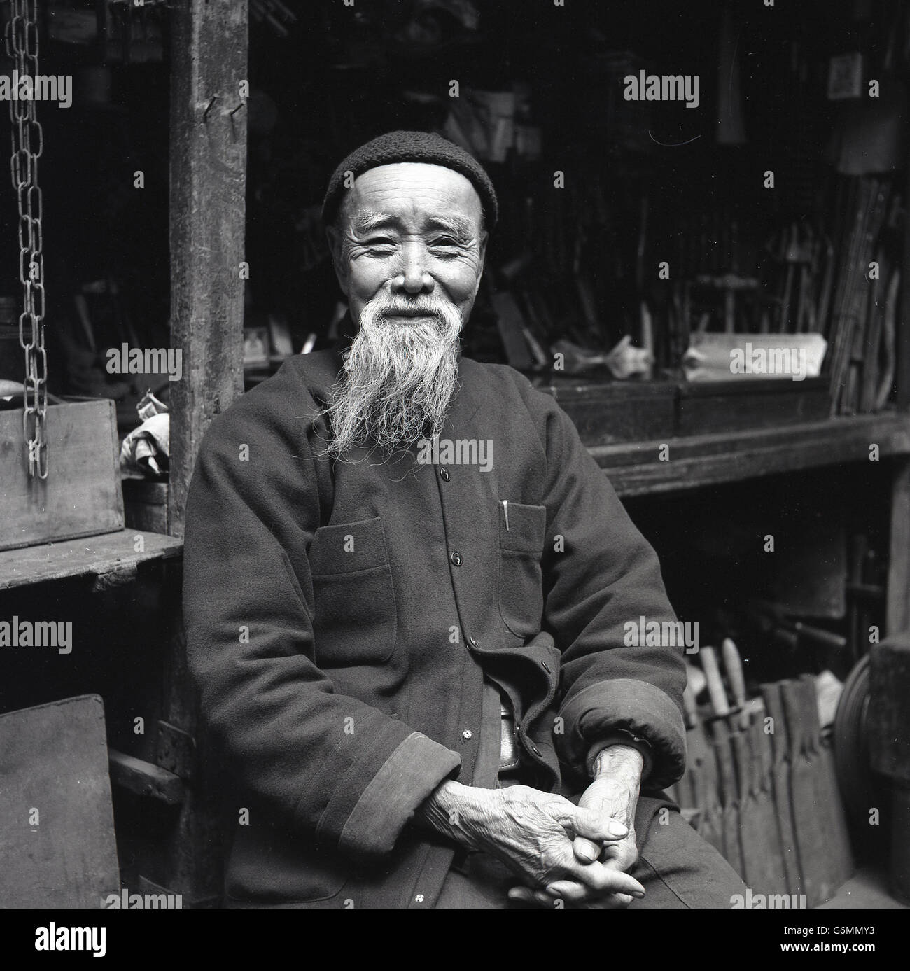 1950s, historical, portrait of a Chinese workman sitting proudly by his ...