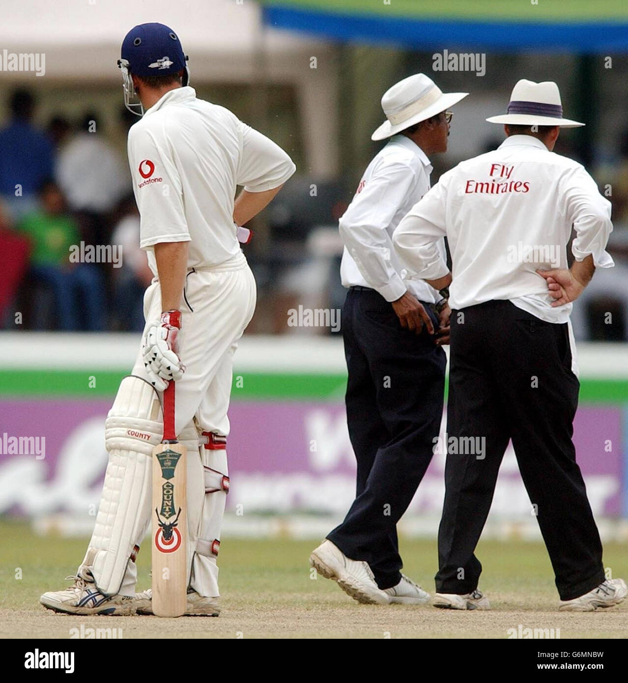 Ashley Giles (left) watches the umpires Srinivas Venkataraghavan and ...