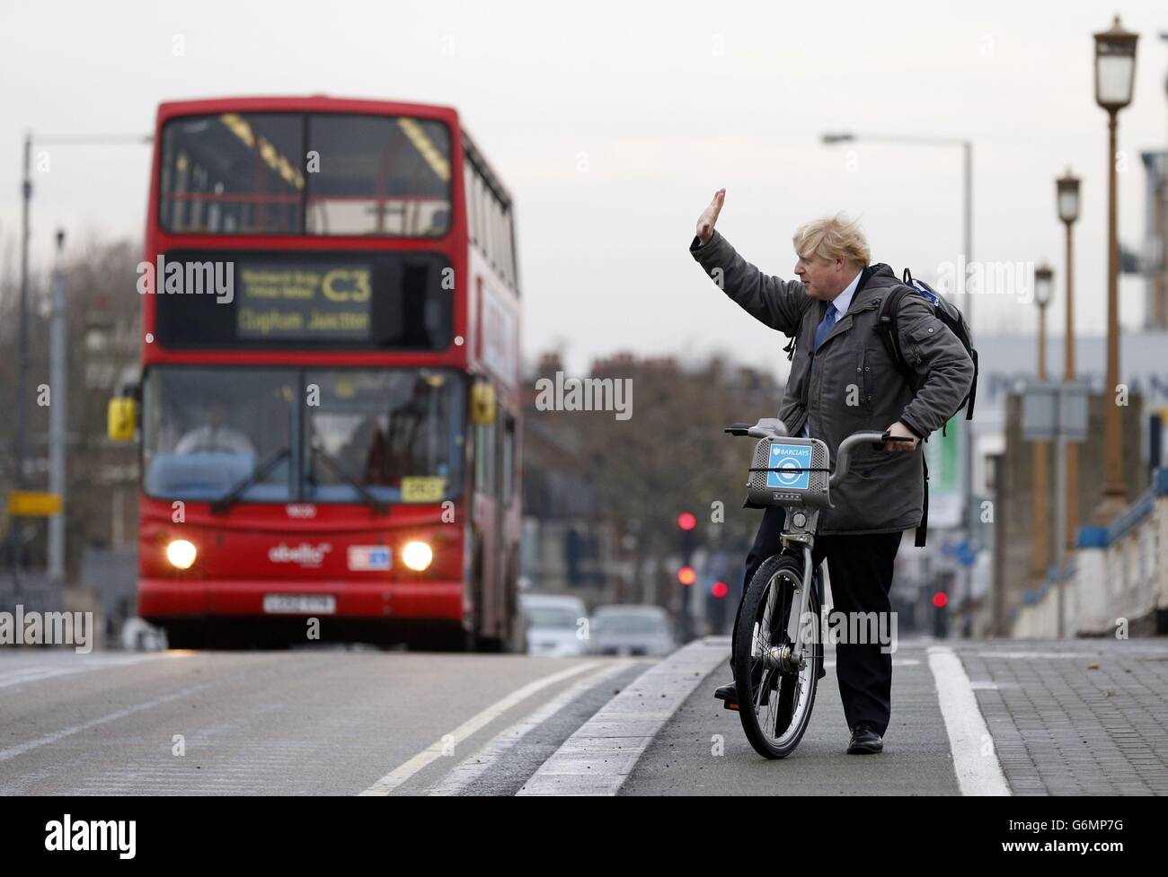 Mayor of London Boris Johnson cycles across Wandsworth Bridge at the ...