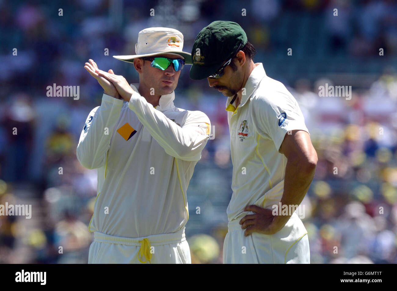 Australia's Michael Clarke (left) speaks with Mitchell Johnson during ...