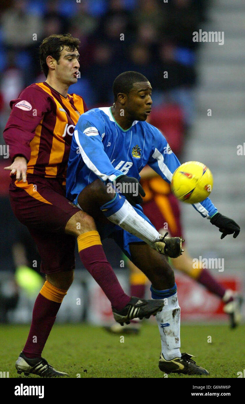 Wigan's Nathan Ellington (right) keeps the ball from Bradford's Jason ...
