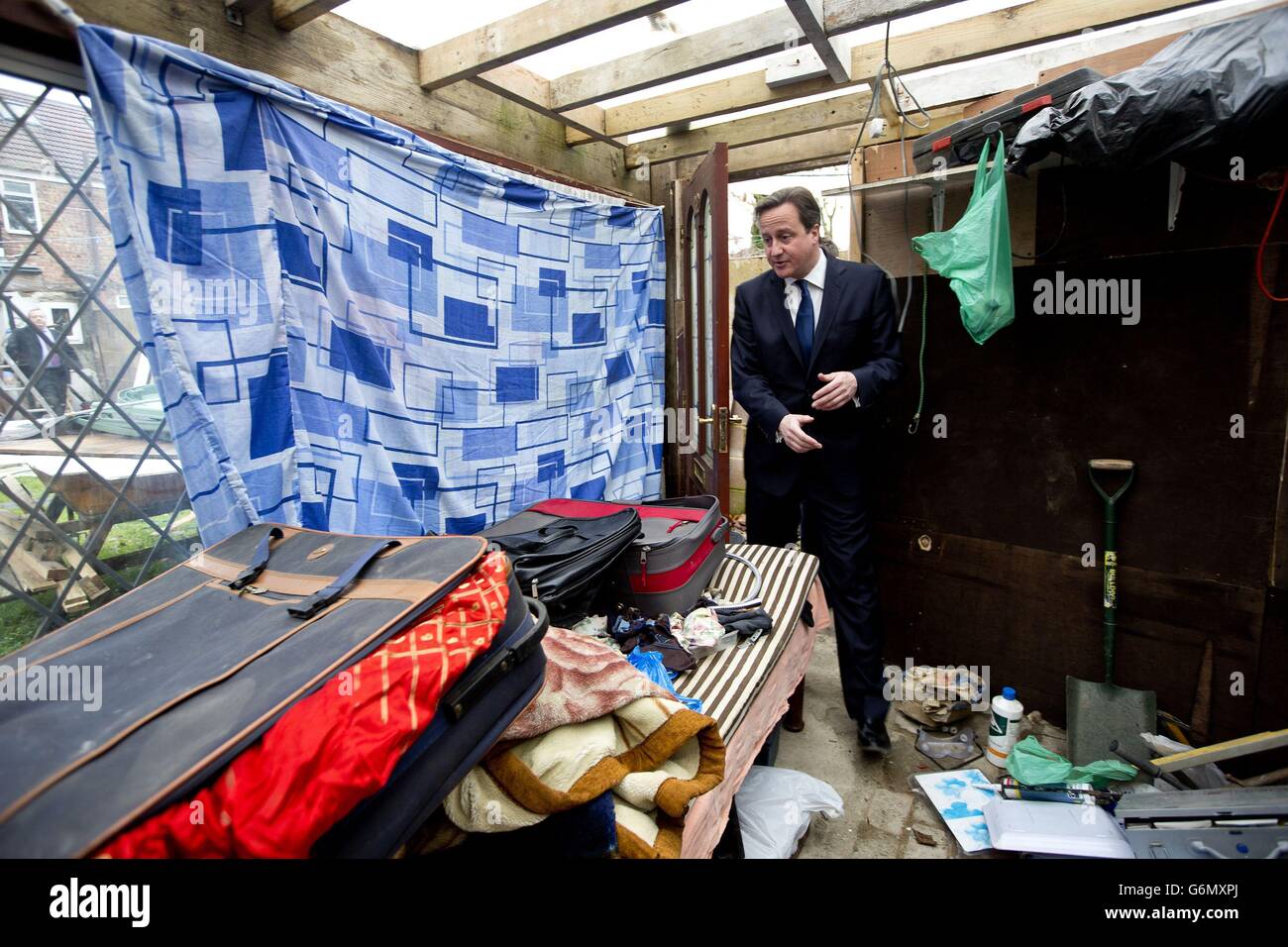 Prime Minister David Cameron is shown around a house in Southall ...