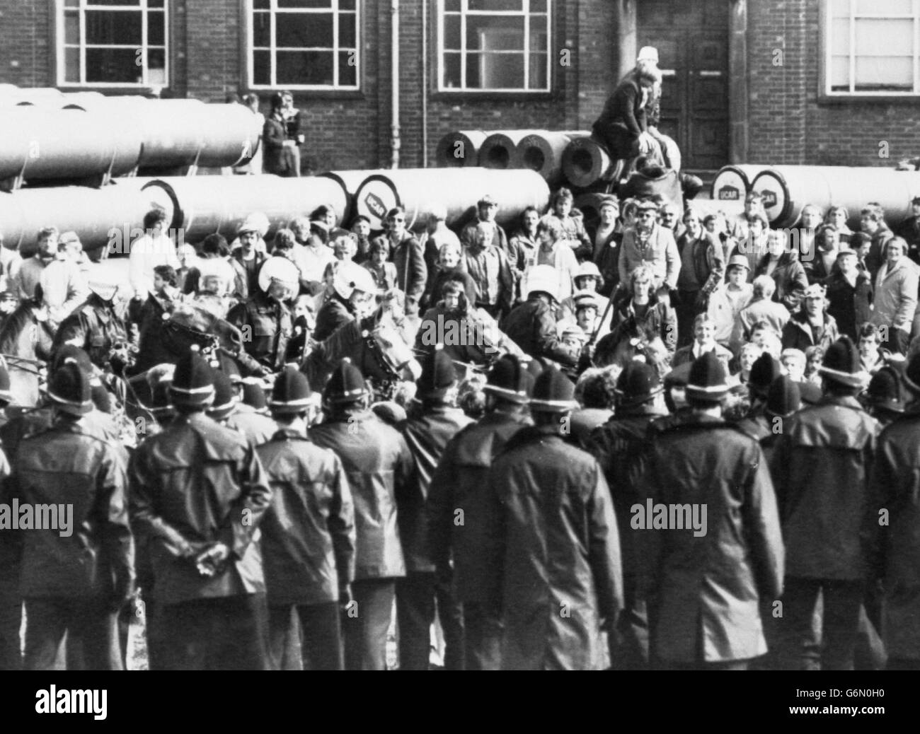 Police officers stand in front of the picket lines at the Orgreave ...