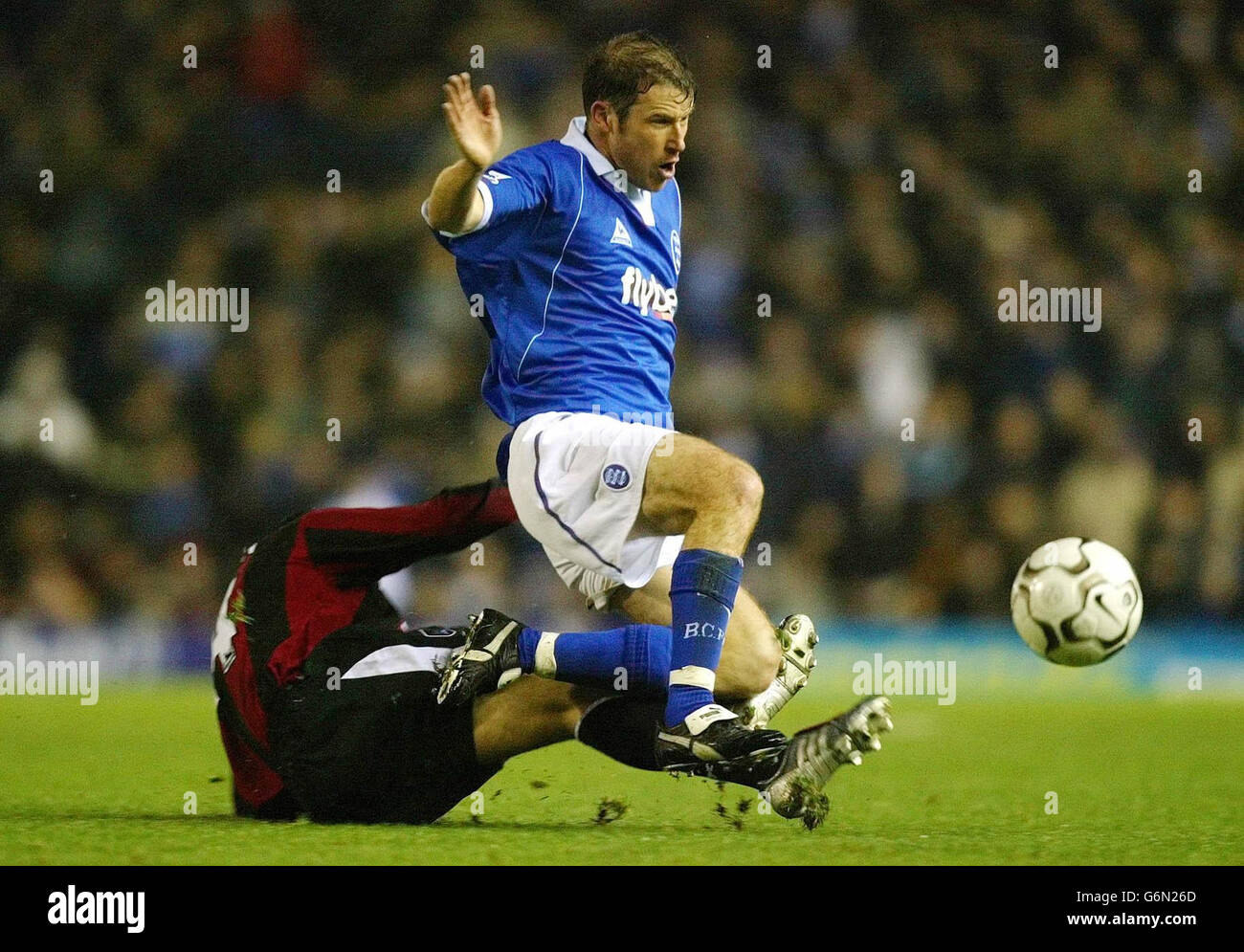 Birmingham City's Kenny Cunningham is tackled by Joey Barton of ...