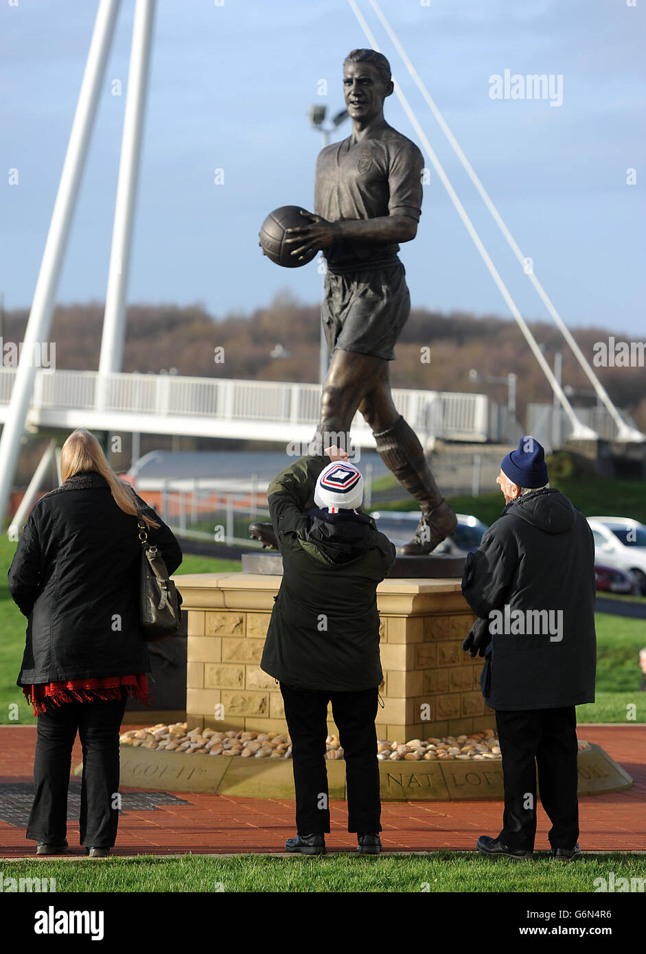 Fans photograph the Nat Lofthouse statue outside the Reebok Stadium ...