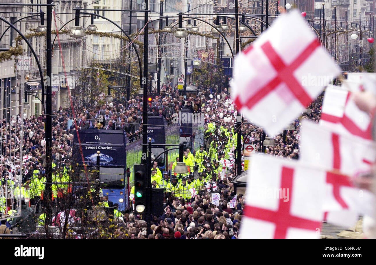 Fans wave their flags as they watch England players celebrate with the ...