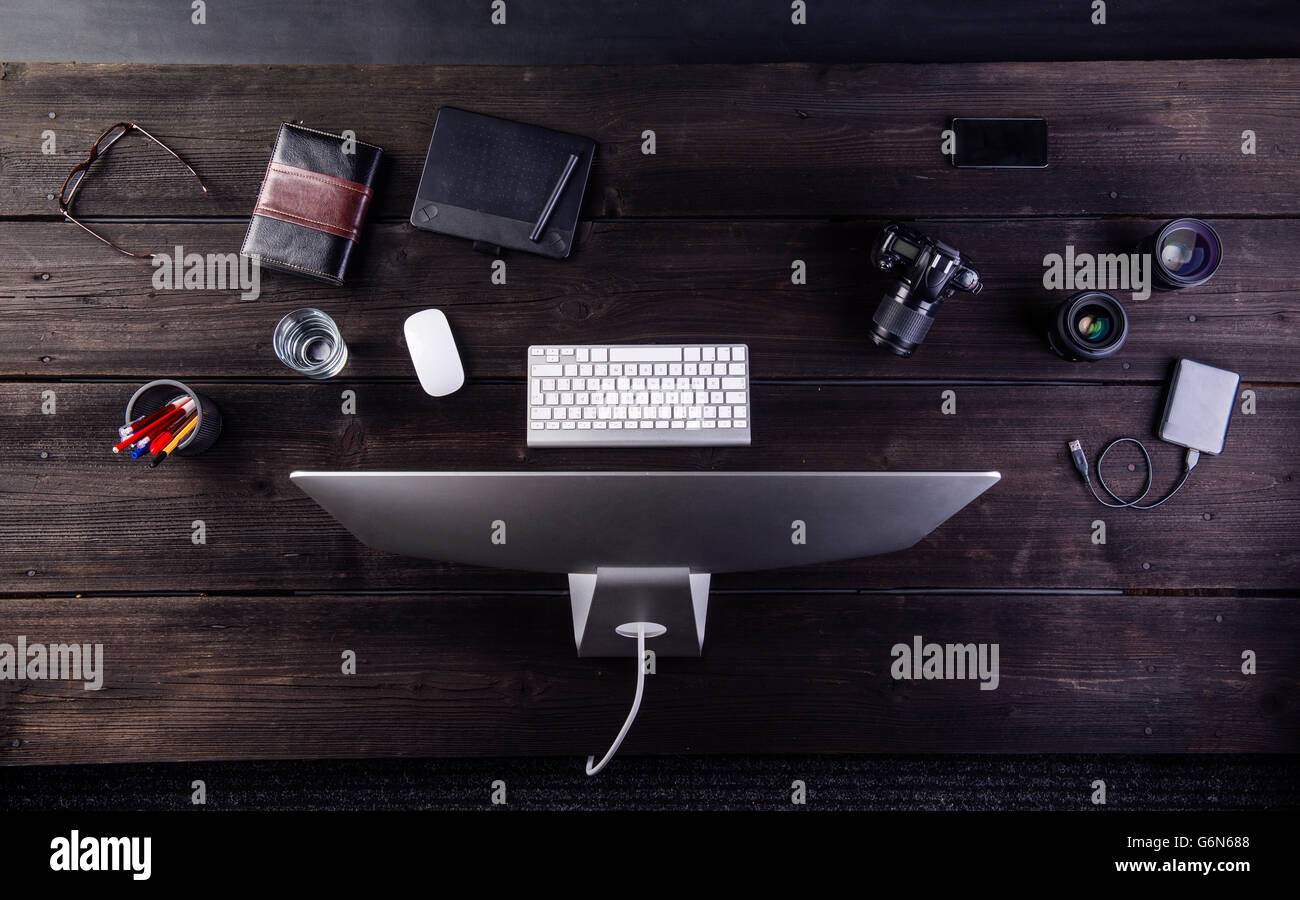 Desk with computer and camera Stock Photo - Alamy