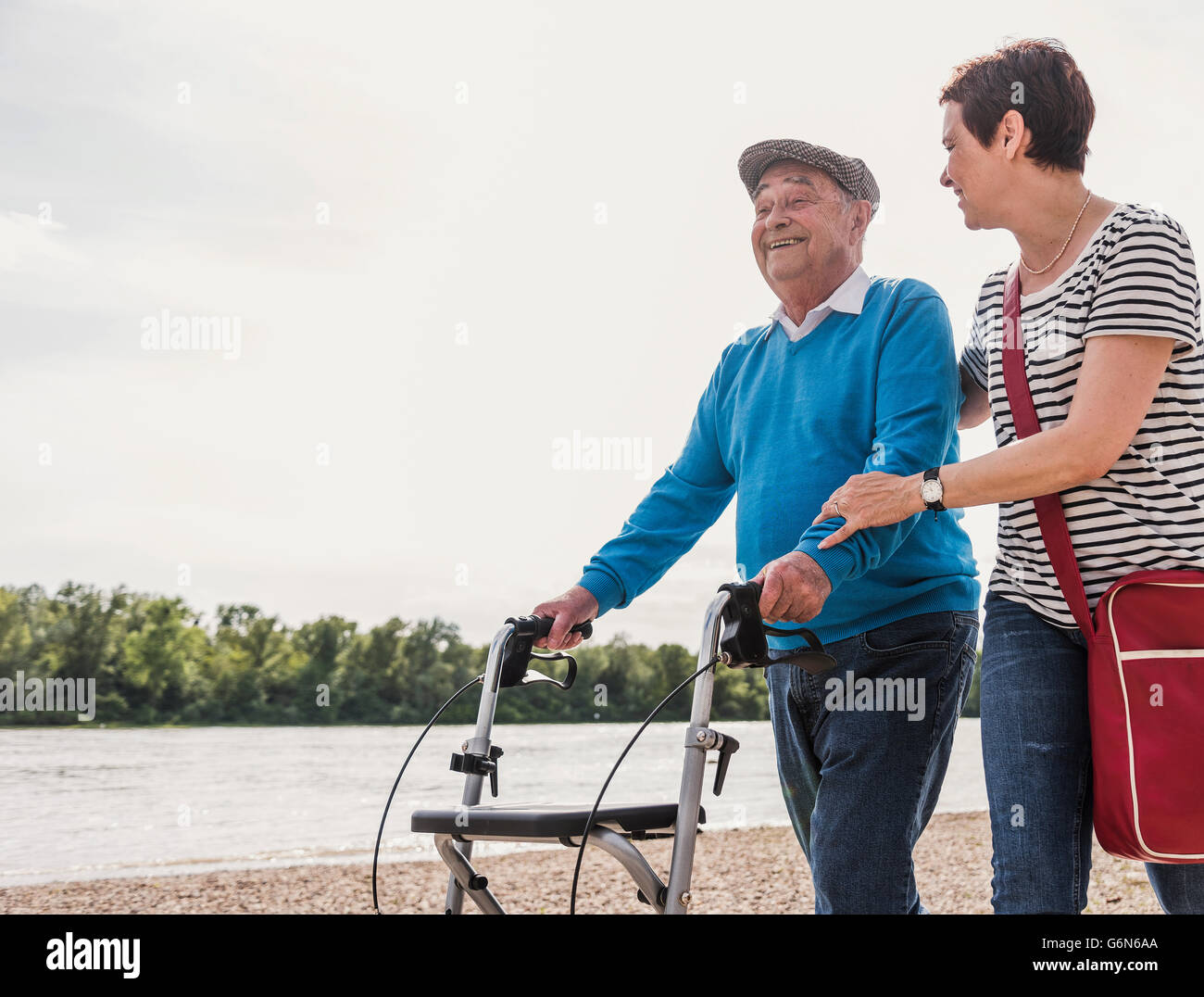 Senior man strolling with his daughter at riverside Stock Photo - Alamy