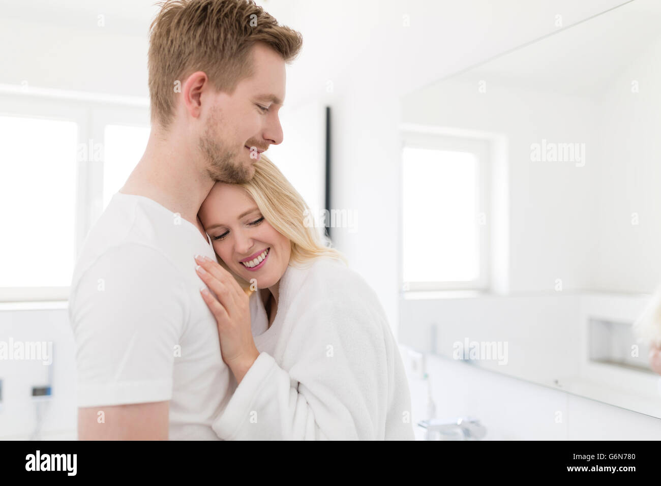 Couple cuddling in bathroom Stock Photo - Alamy