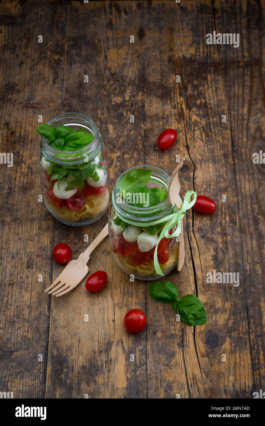 Calabrese salad with pasta, tomatoes, mozzarella, rocket and basil in ...