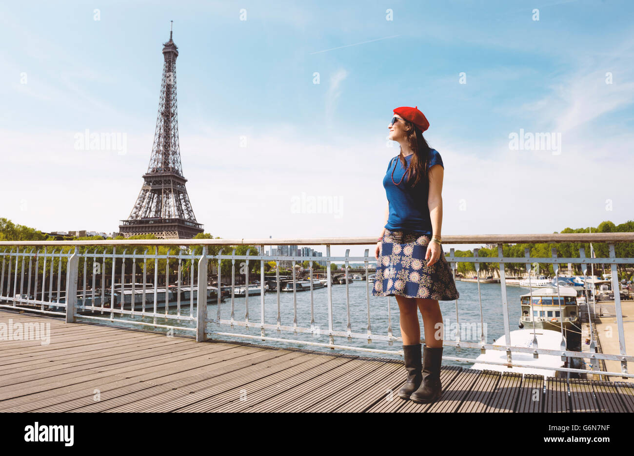 France, Paris, woman wearing red beret standing in front of Seine river ...