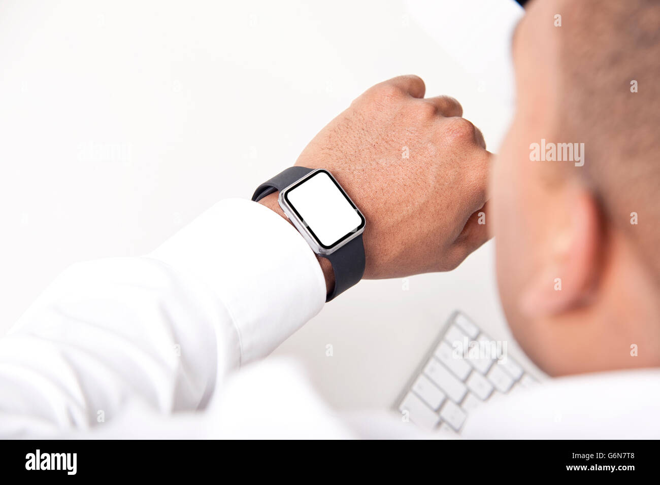 Man looking at his smartwatch, close-up Stock Photo - Alamy