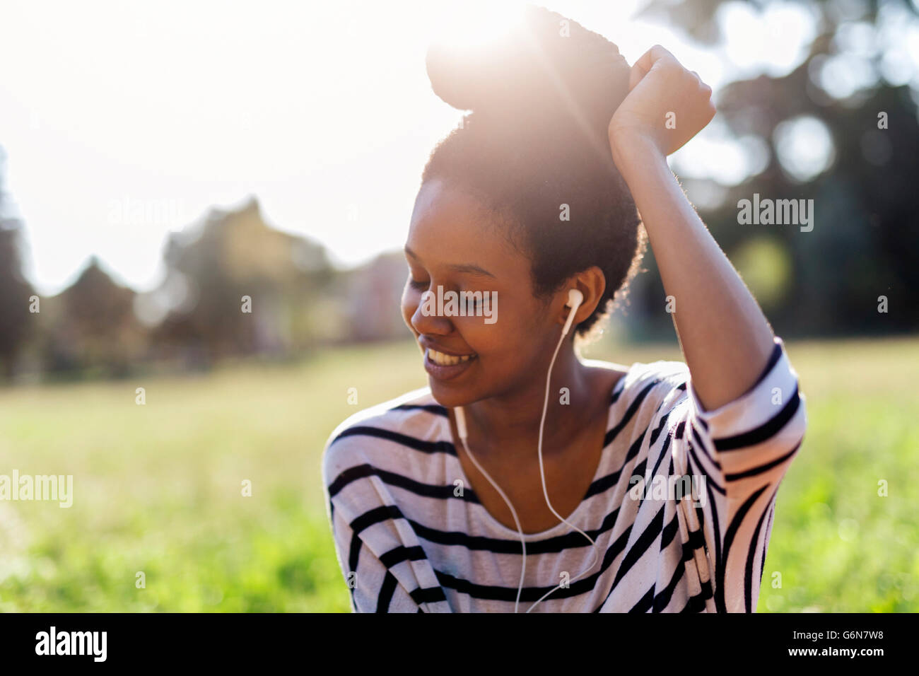 Smiling woman hearing music with earphones Stock Photo - Alamy