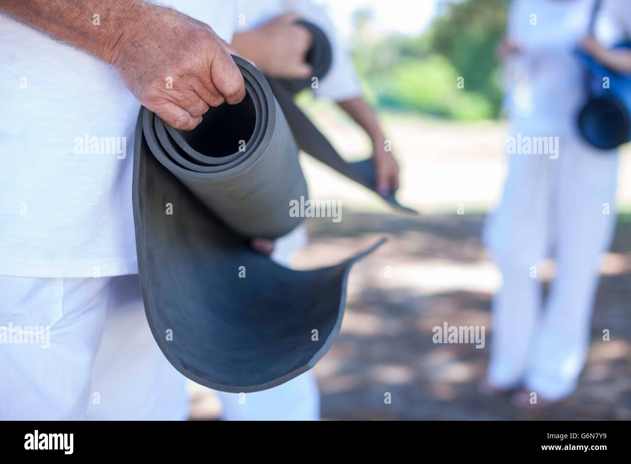 Man rolling yoga mat hi-res stock photography and images - Alamy