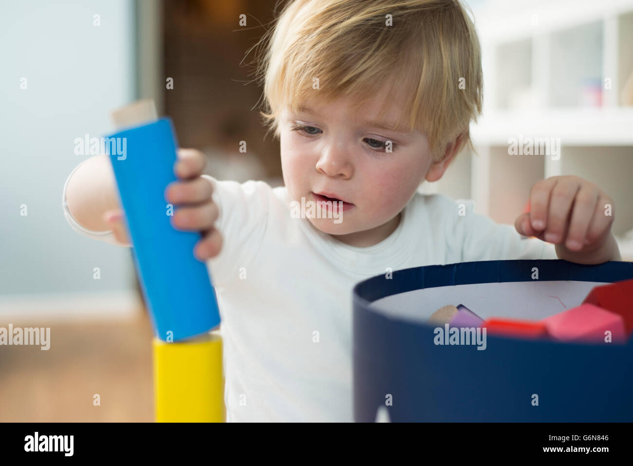 Little boy playing with building blocks Stock Photo - Alamy