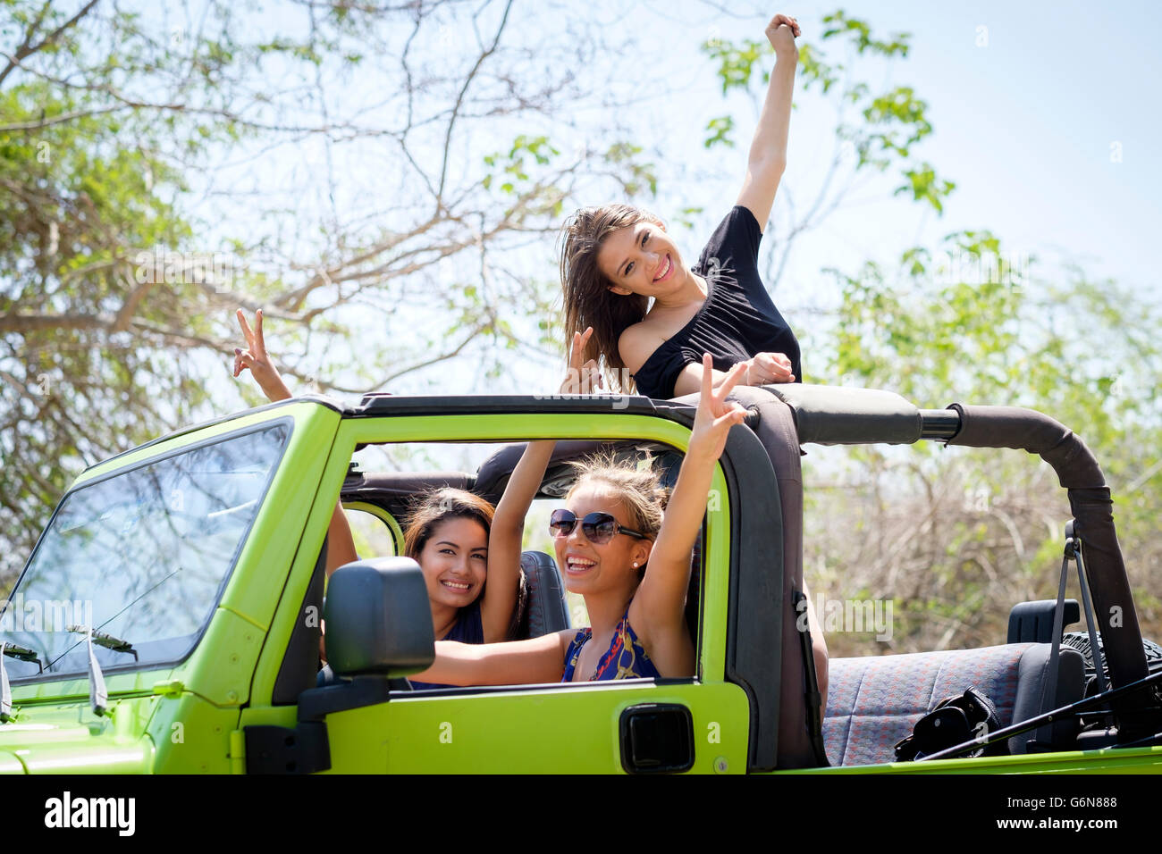 Three friends having fun in off-road vehicle Stock Photo - Alamy