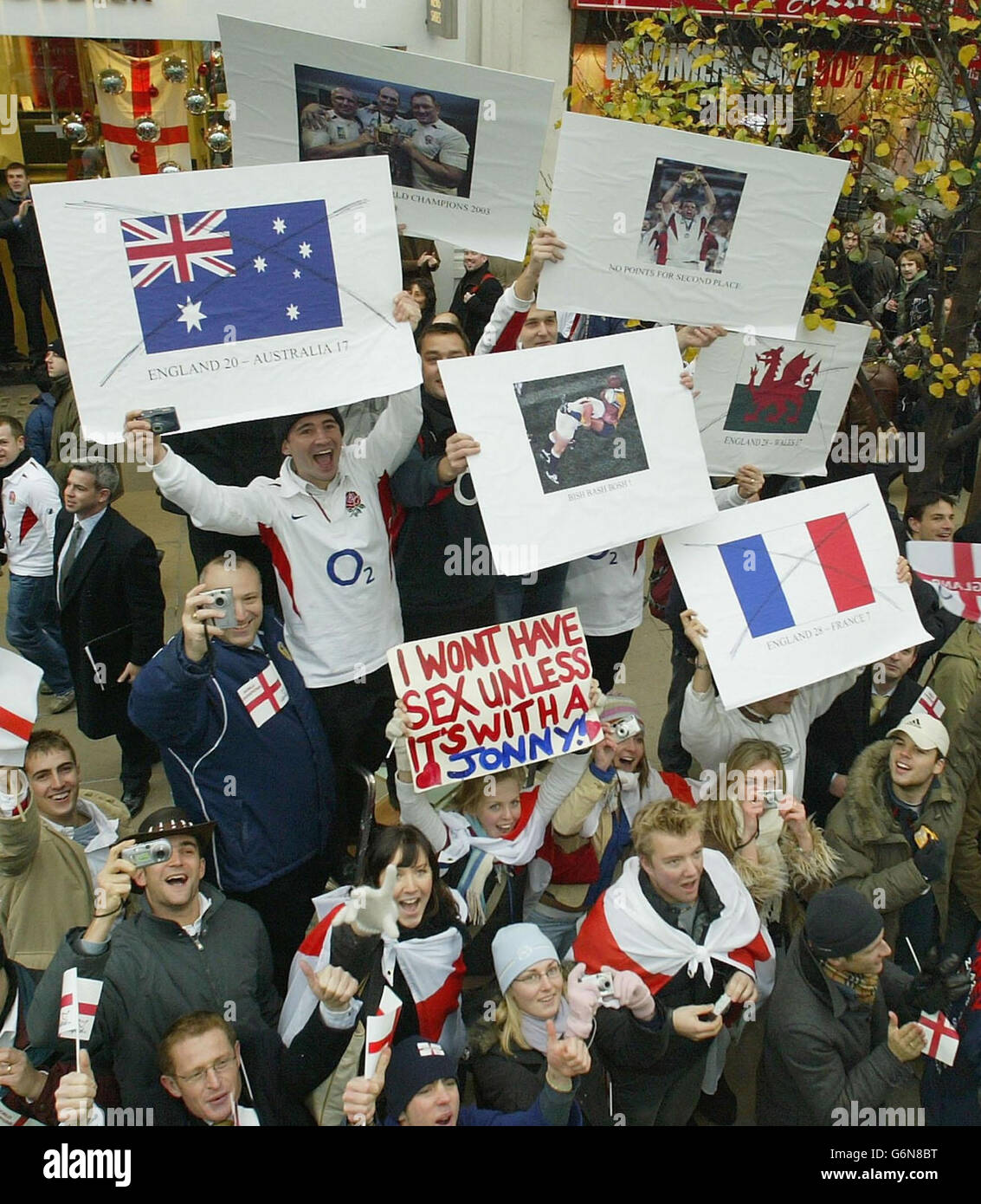 Fans watch the England team bus go past during the England Rugby World ...