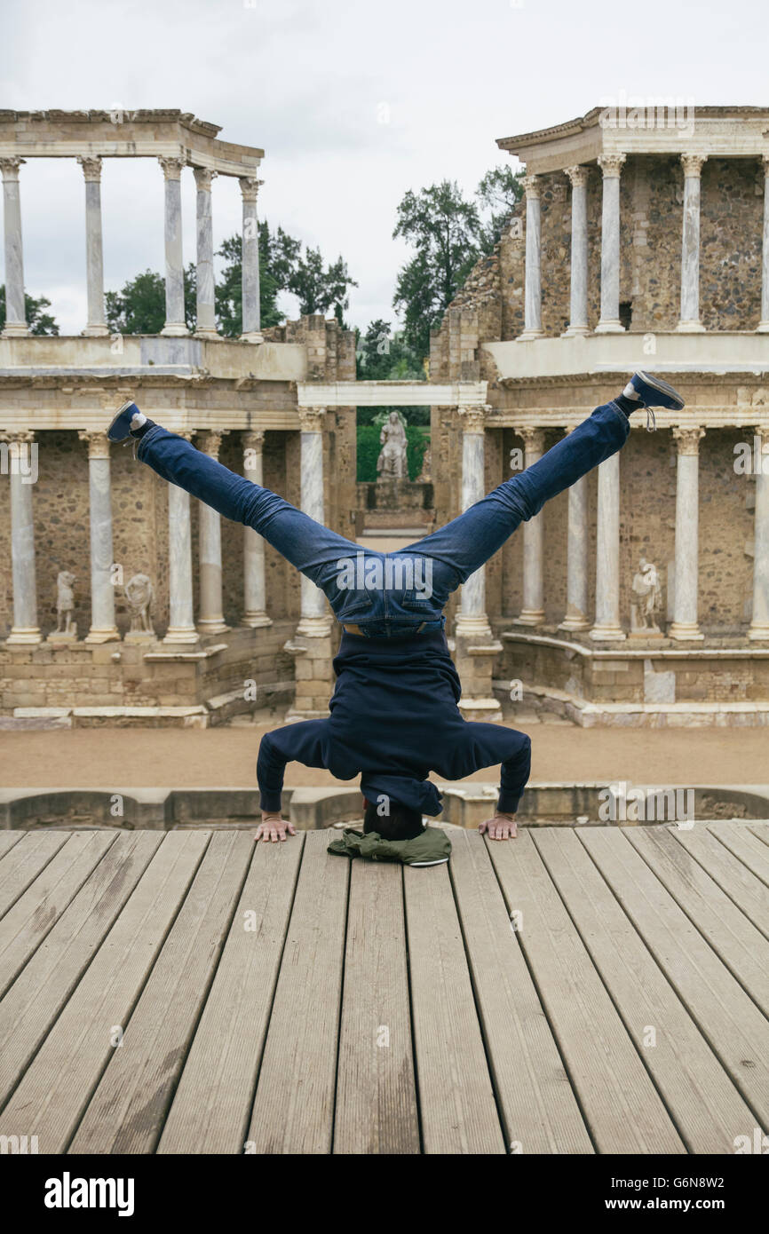 Spain, Merida, man doing a handstand with legs extended Stock Photo - Alamy