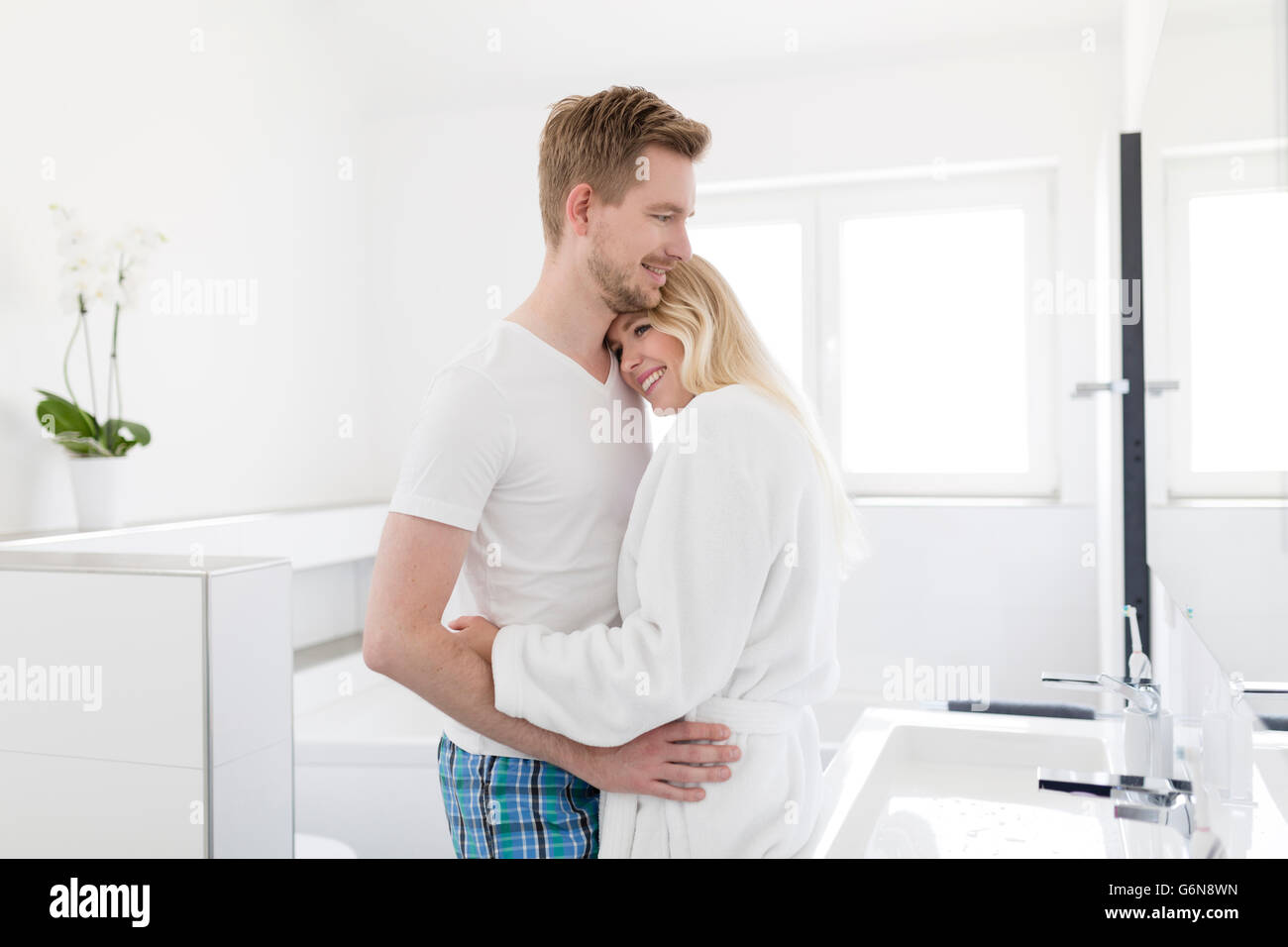 Couple cuddling in bathroom Stock Photo - Alamy