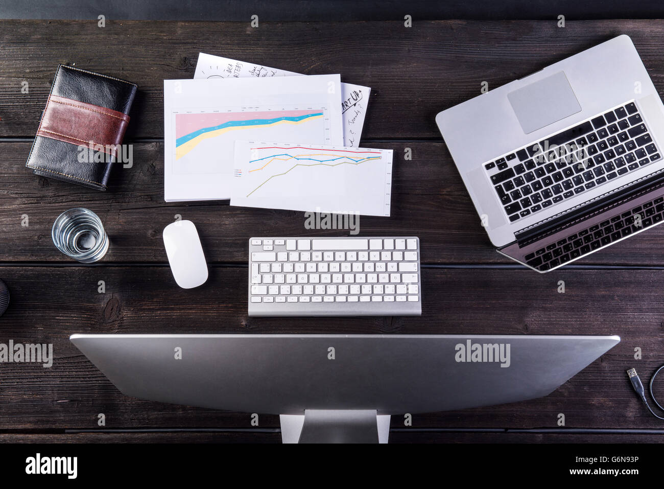 Desk with computers and charts hi-res stock photography and images - Alamy