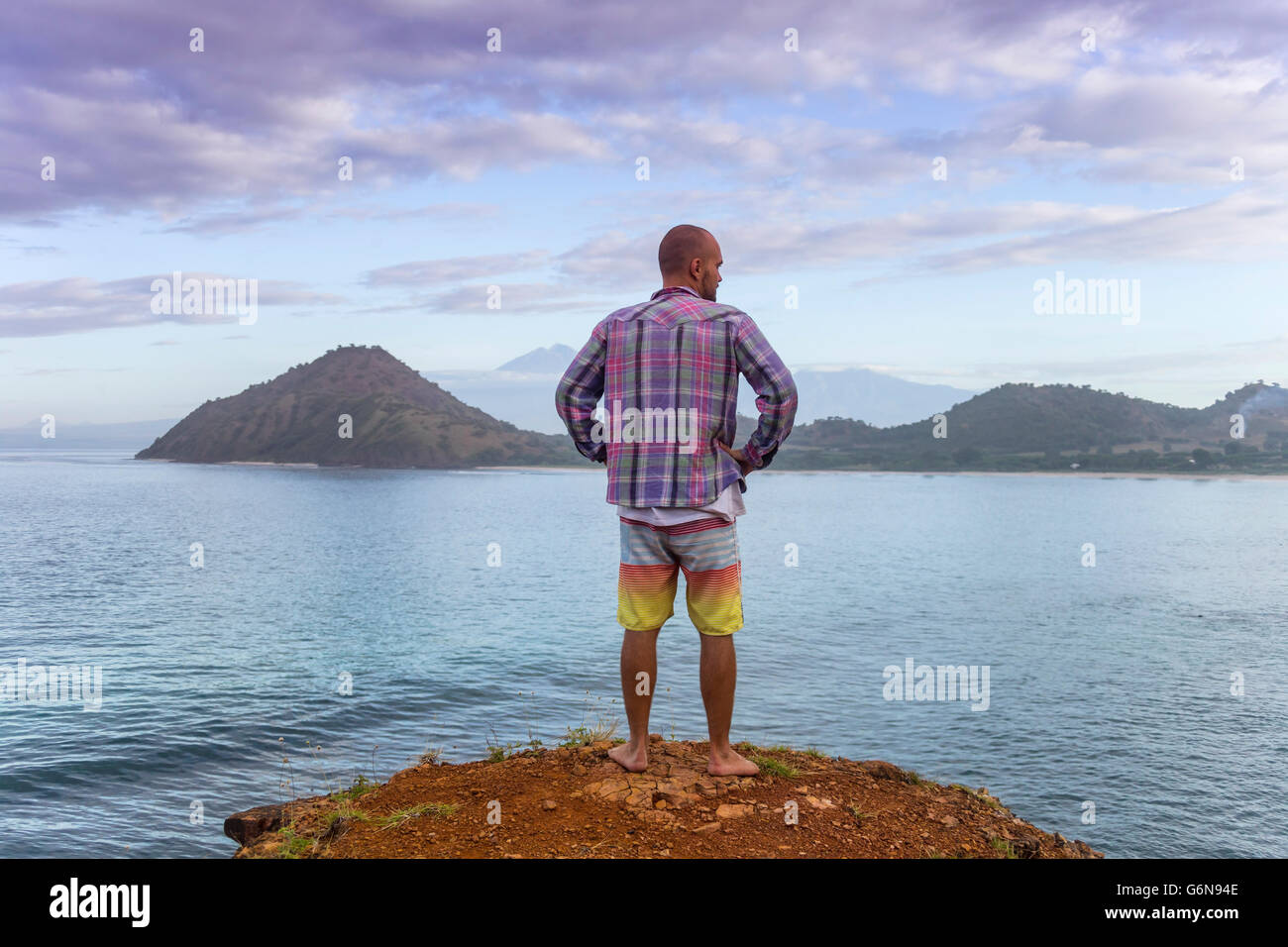 Indonesia, Sumbawa island, Young man standing on viewpoint Stock Photo ...