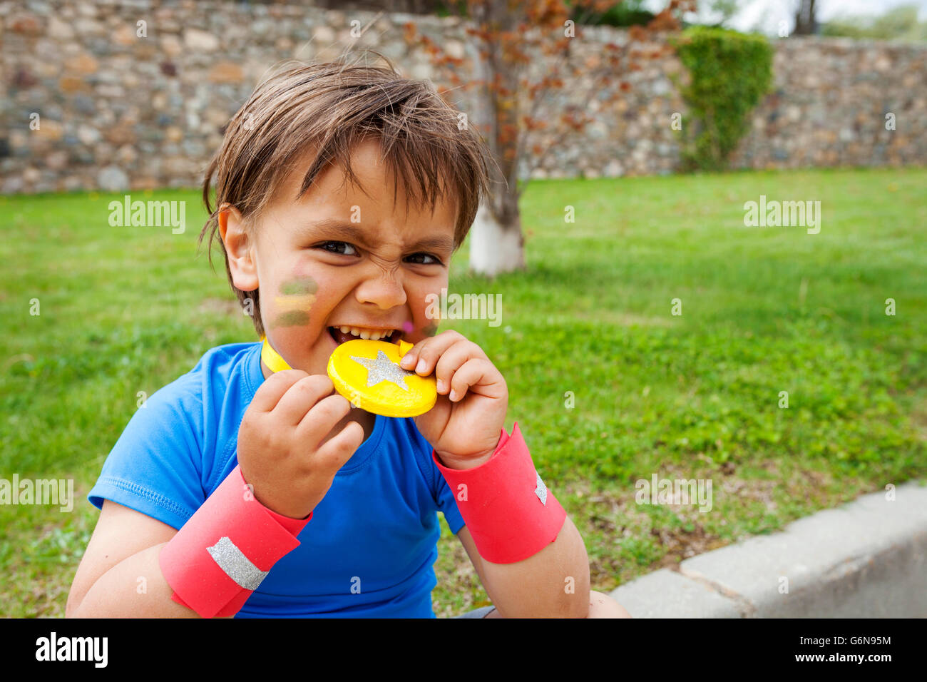 Little boy biting on medal Stock Photo - Alamy