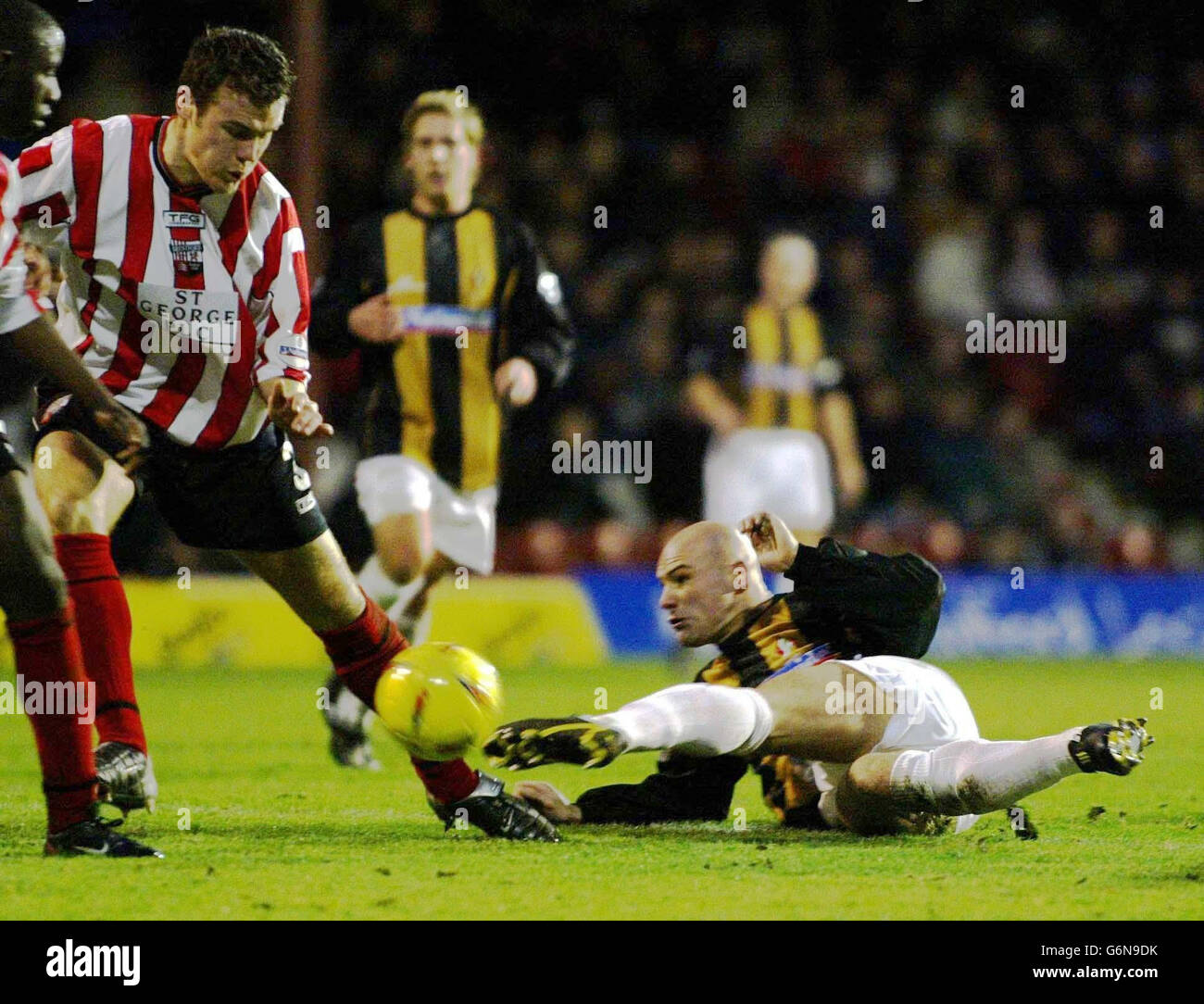 Brentford's Matt Somner (L) challenges Swindon's Tommy Mooney during ...