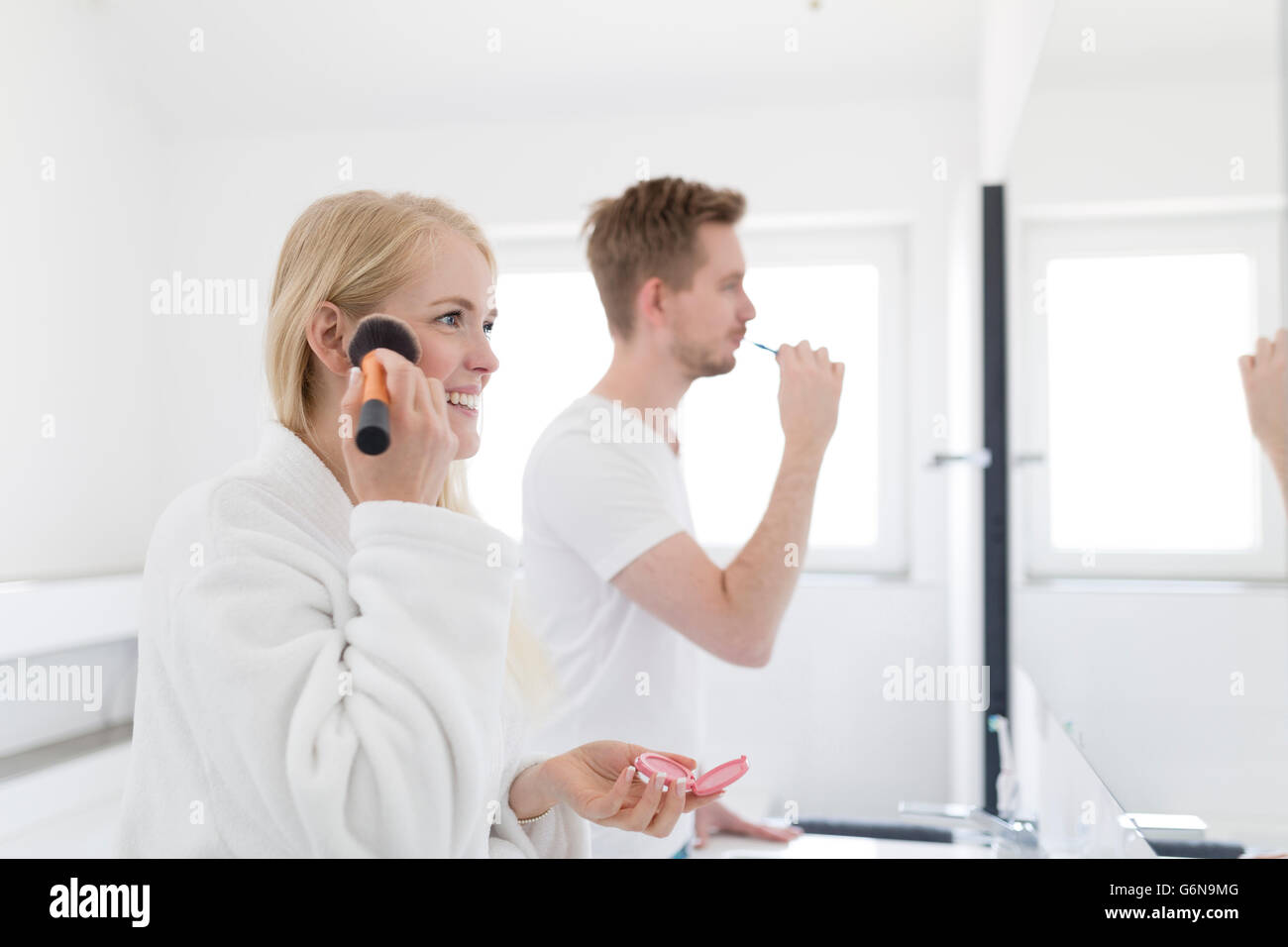 Couple grooming in bathroom Stock Photo - Alamy
