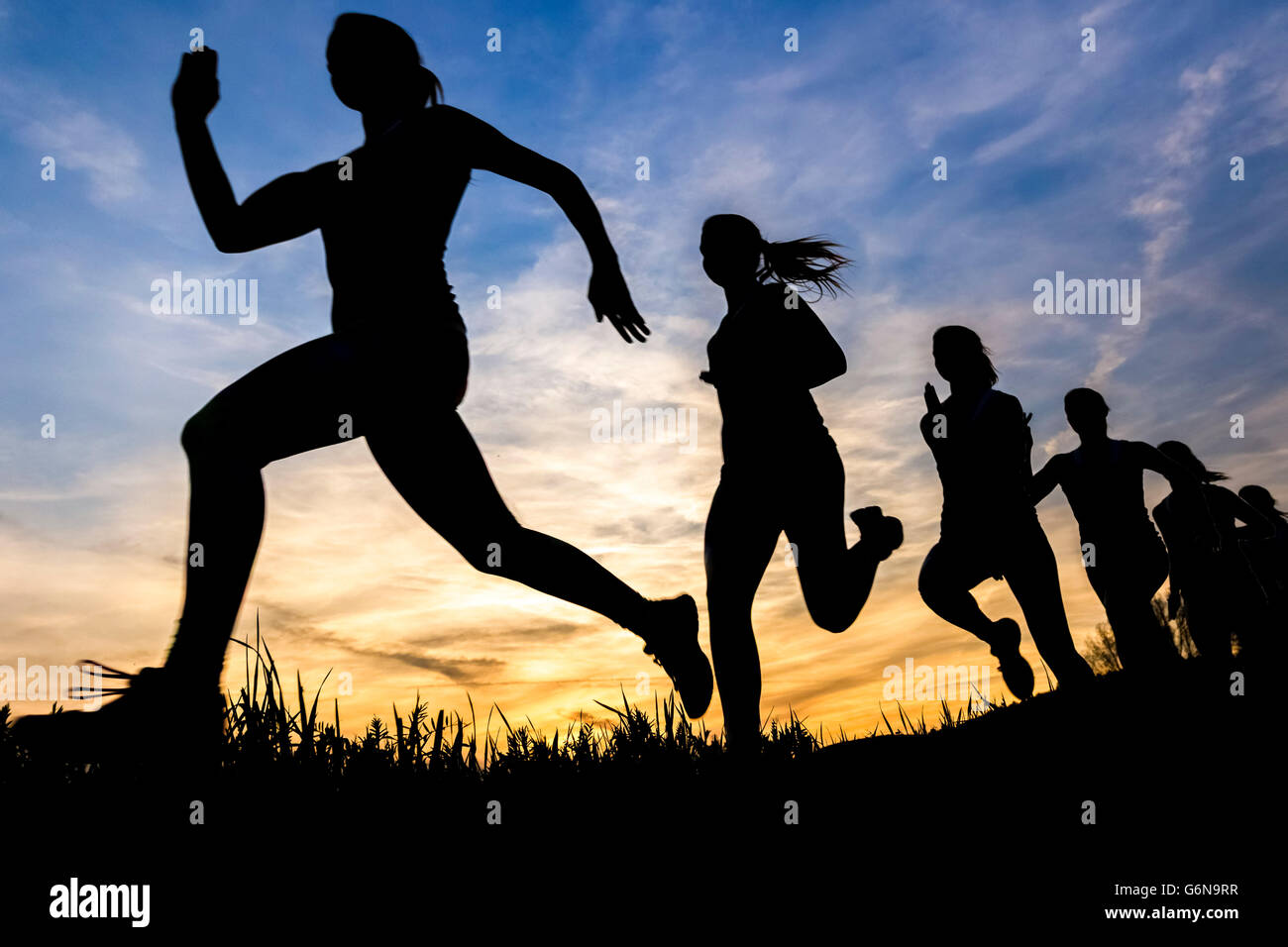 Silhouette of female jogger at sunset, sequence, phases Stock Photo - Alamy