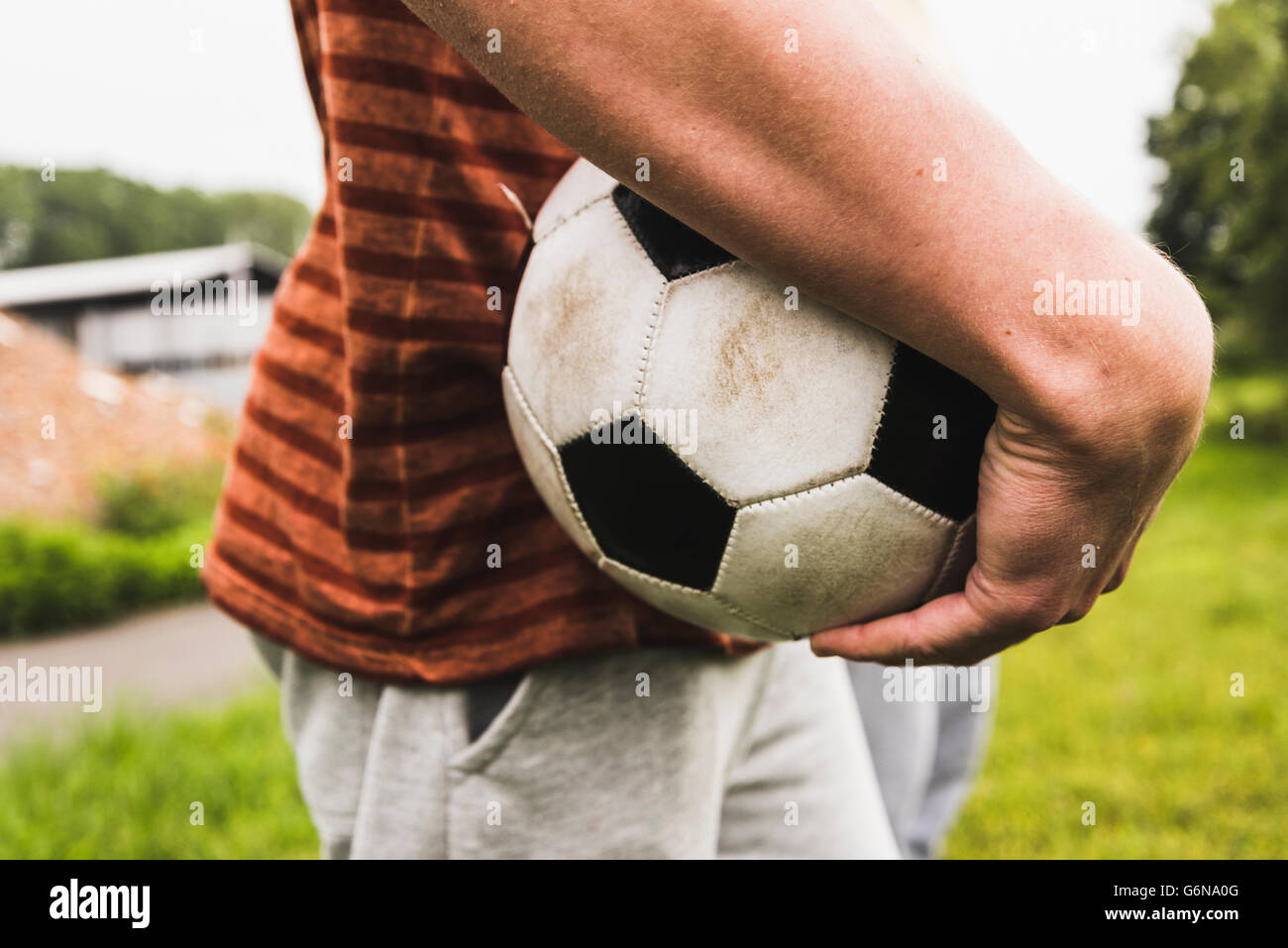 Close-up of man holding football Stock Photo - Alamy