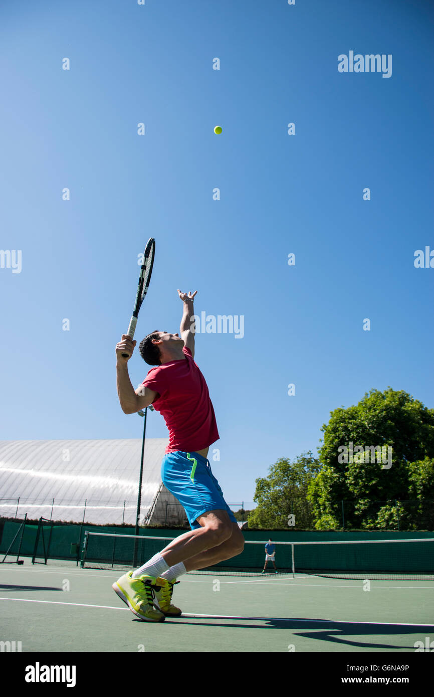 Tennis player serving a tennis ball during a tennis match Stock Photo ...