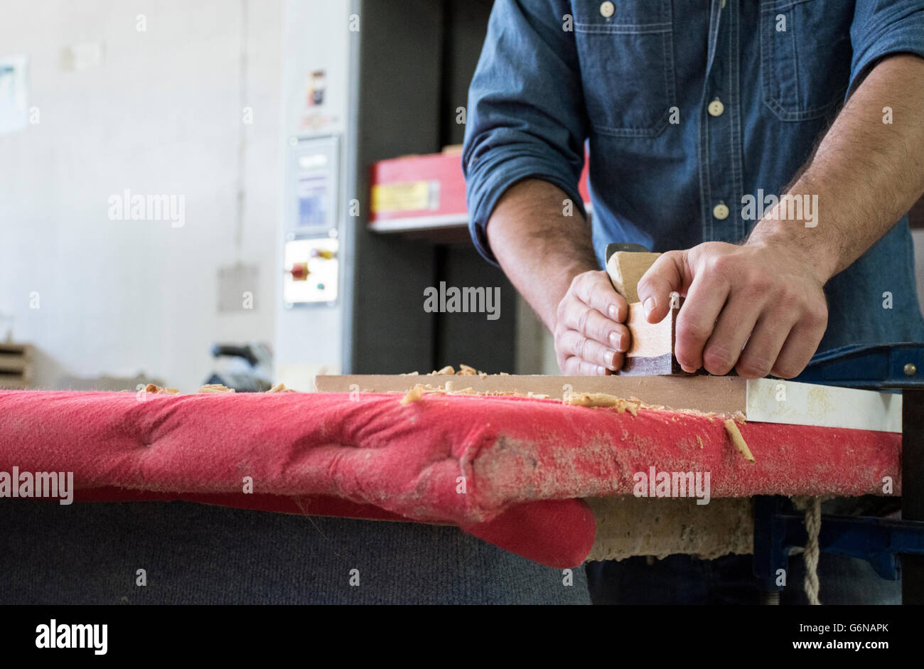 Hands of a carpenter using a hand plane Stock Photo - Alamy