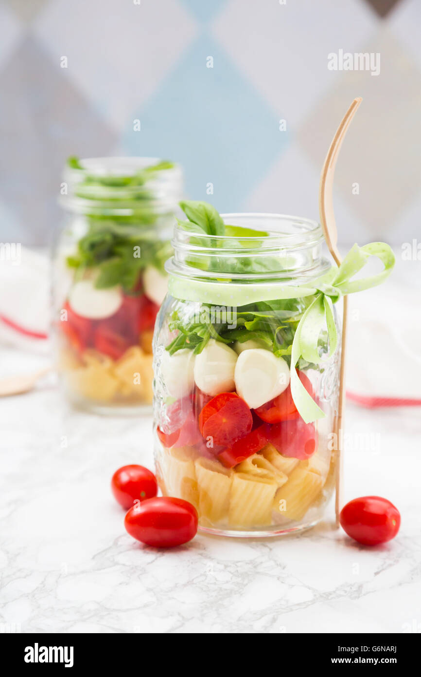 Calabrese salad with pasta, tomatoes, mozzarella, rocket and basil in ...