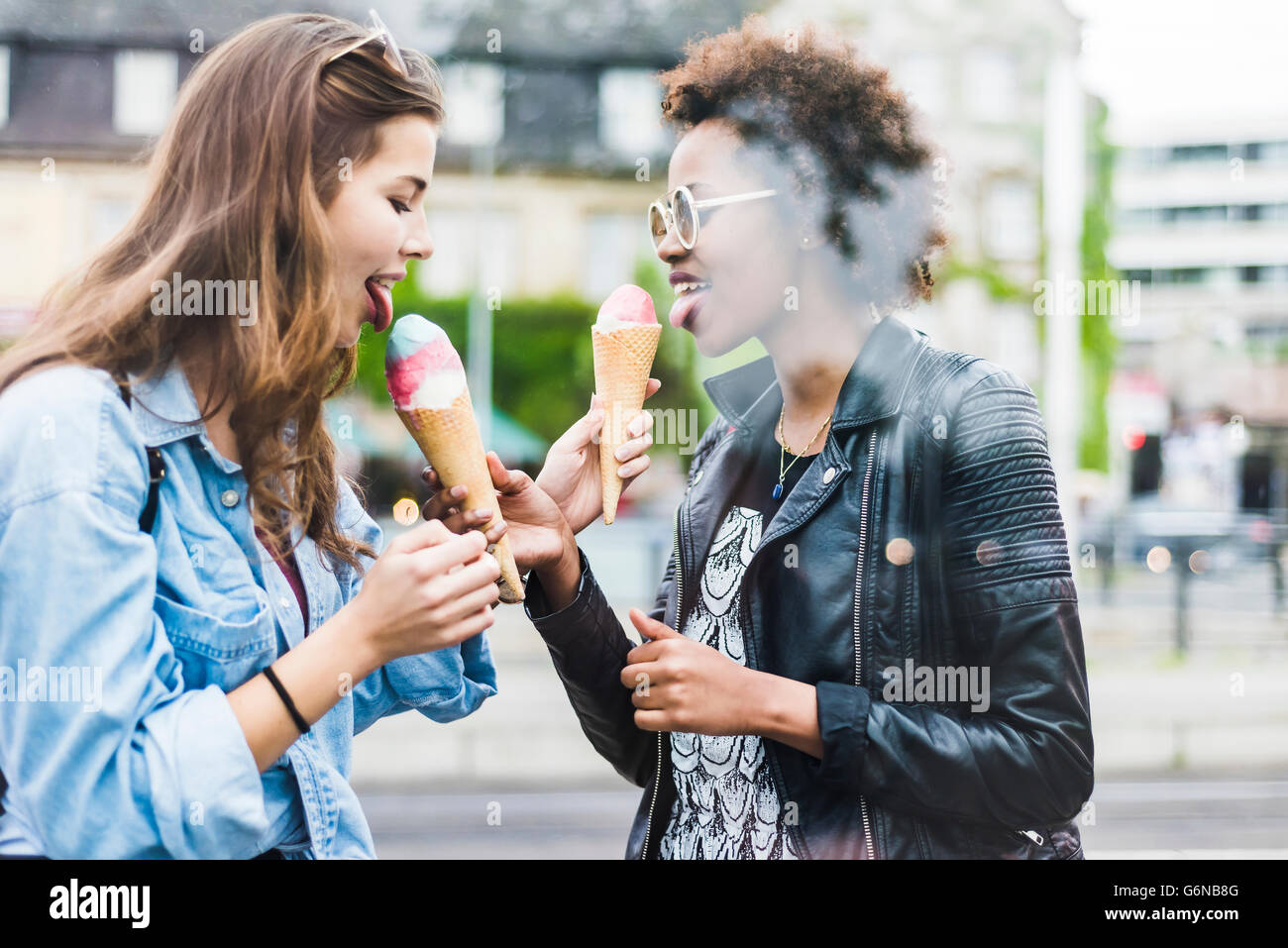 Two best friends eating icecream together Stock Photo - Alamy