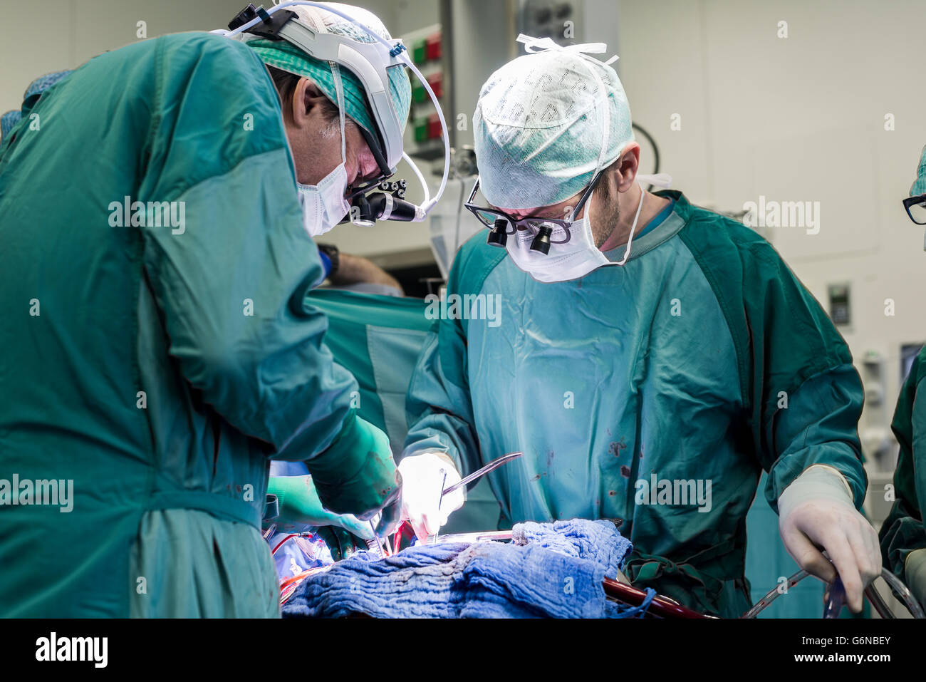 Heart surgeons and operating room nurse during a heart valve operation ...