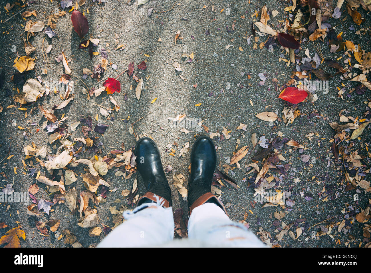 Teenage girl standing on path with autumn leaves Stock Photo - Alamy