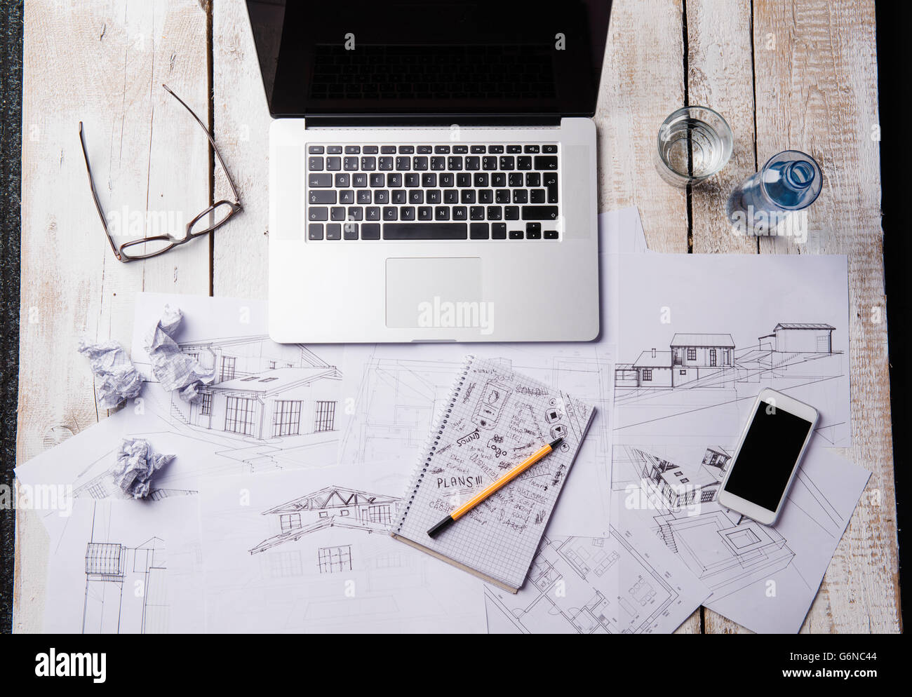 Desk of an architect with laptop and sketches Stock Photo - Alamy