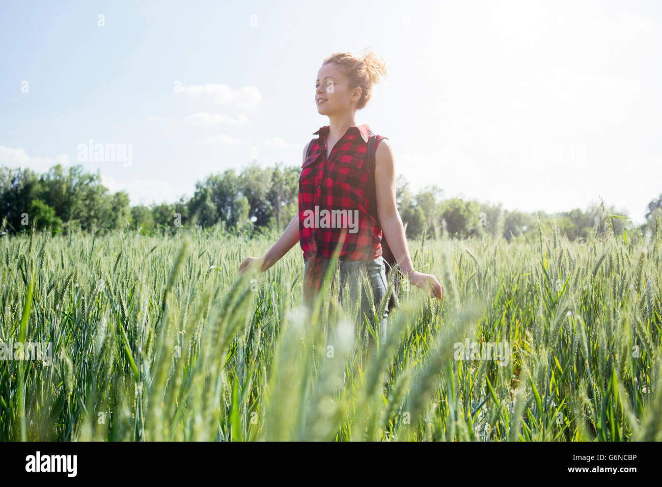 Woman standing in a field Stock Photo - Alamy
