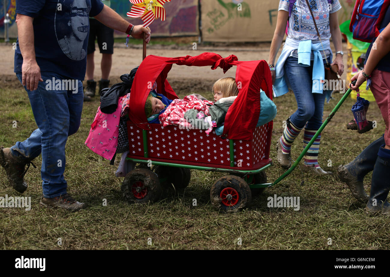 Young festivalgoers are pulled along in a trolley at the Glastonbury ...