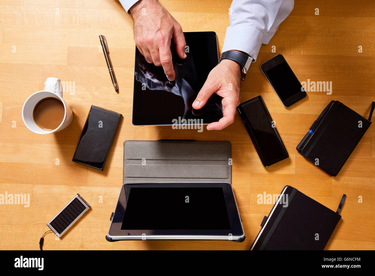 Overhead view of businessman using technology Stock Photo - Alamy